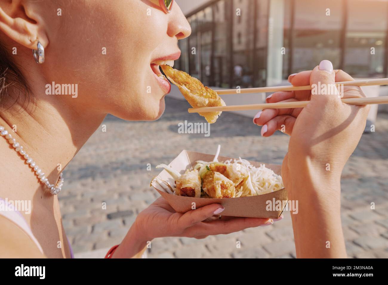 Woman eating vietnamese spring rolls hi-res stock photography and ...