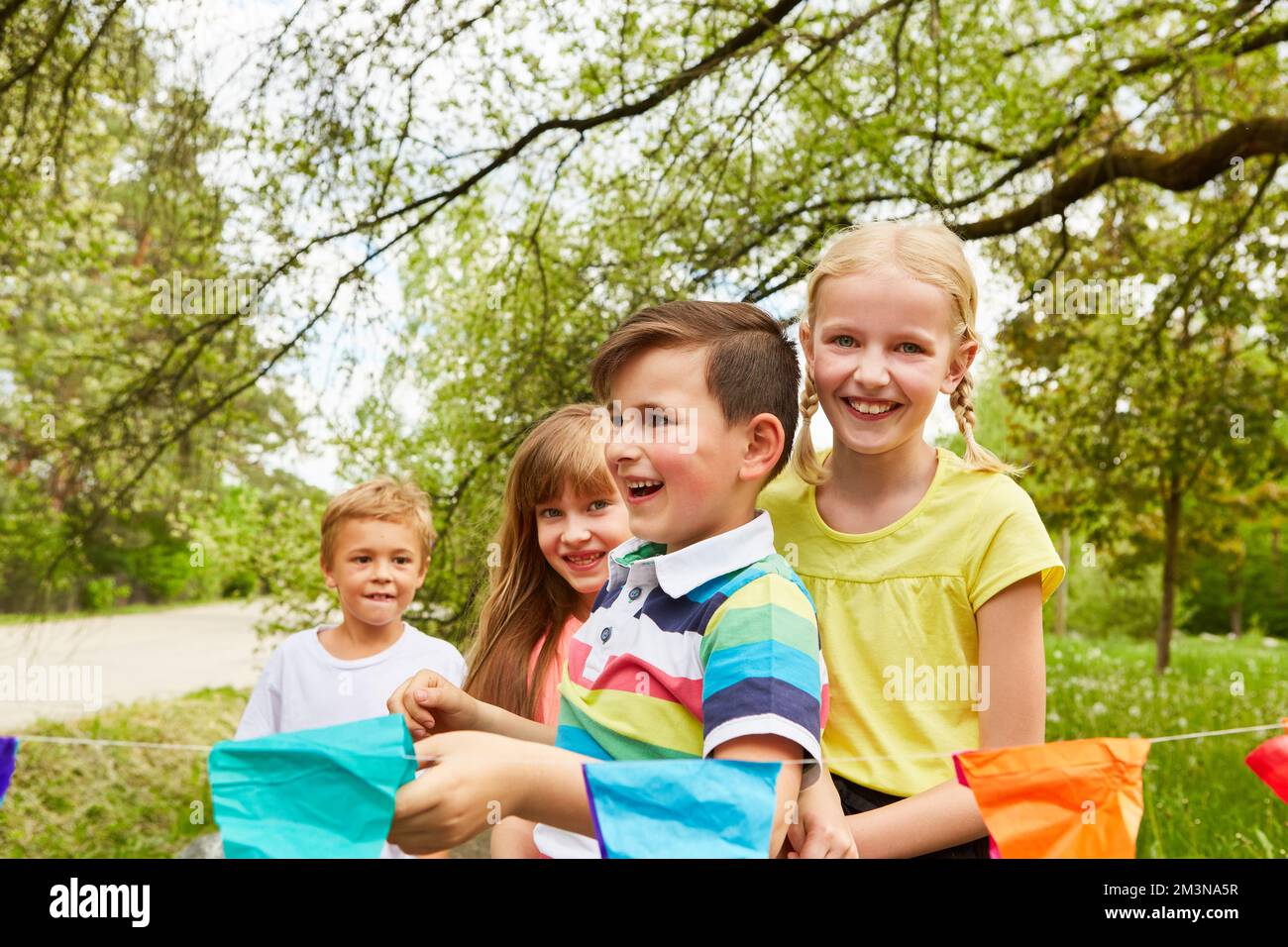 Smiling multiracial male and female friends standing at finish line ...