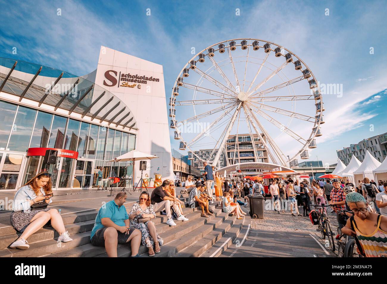 29 July 2022, Cologne, Germany: People and tourist resting near ferris ...