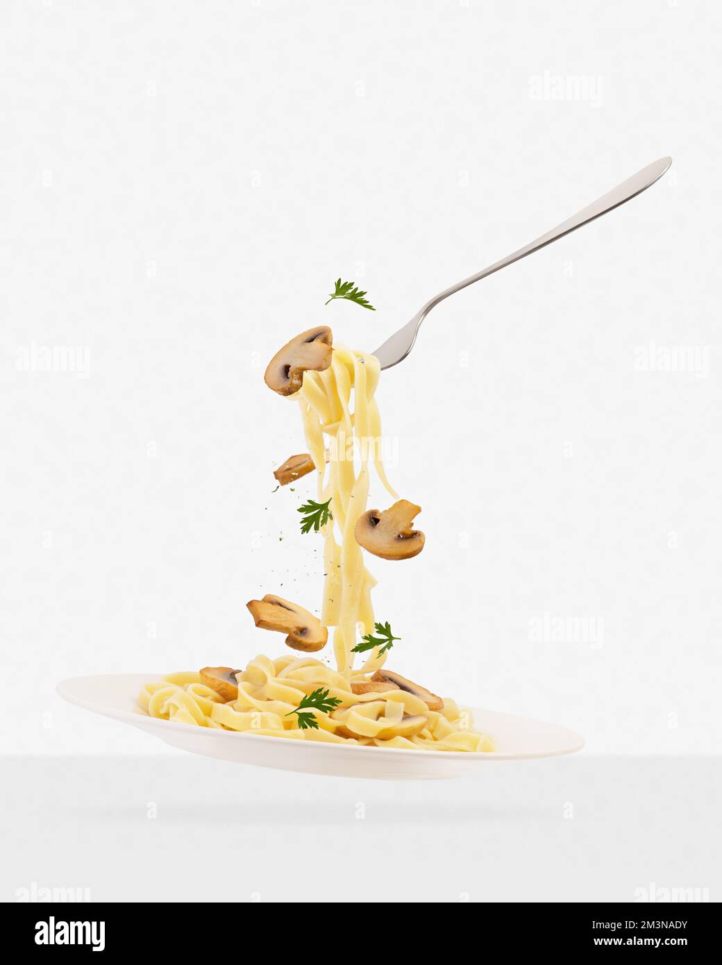 pasta with mushrooms on a white background. Falling ingredients ...