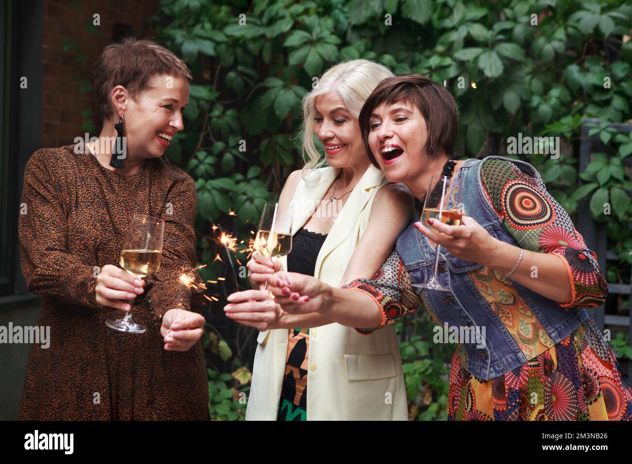 Group of Senior women Friends celebrate, have fun with sparklers and ...