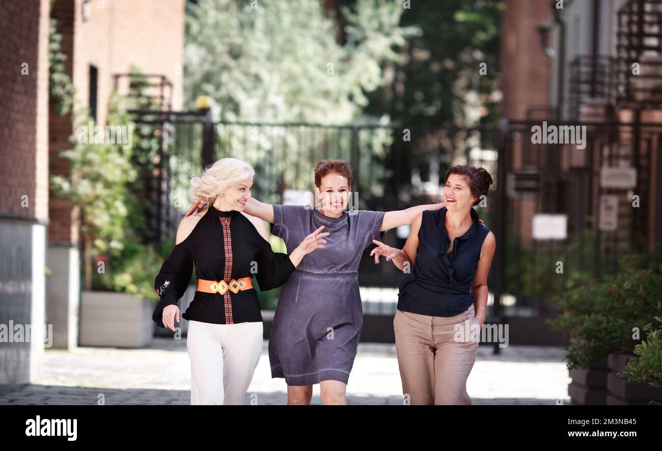 Smiling mature women. Happy group Middle aged female friends walking ...