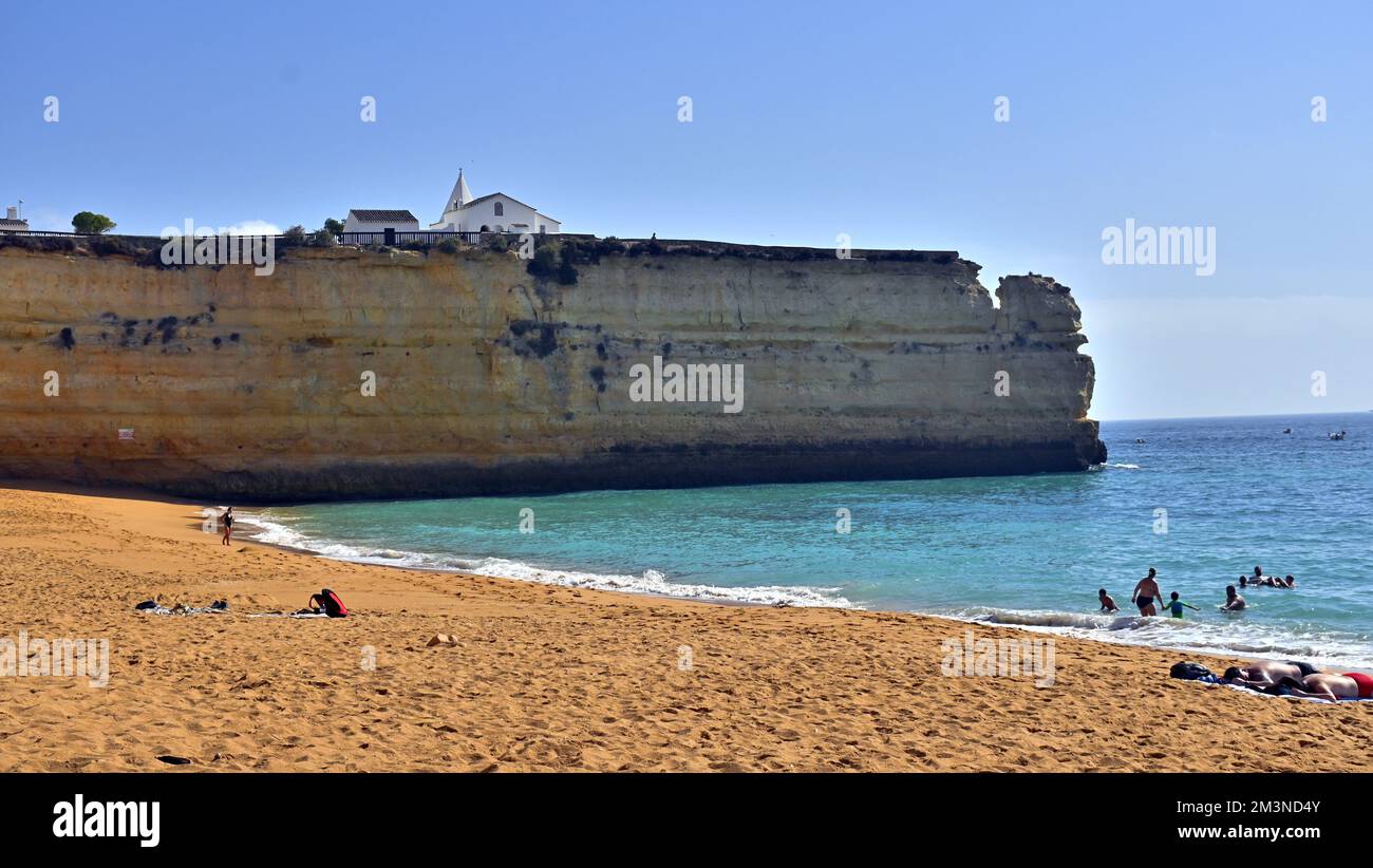 A beautiful sunny beach with tall cliffs Stock Photo - Alamy