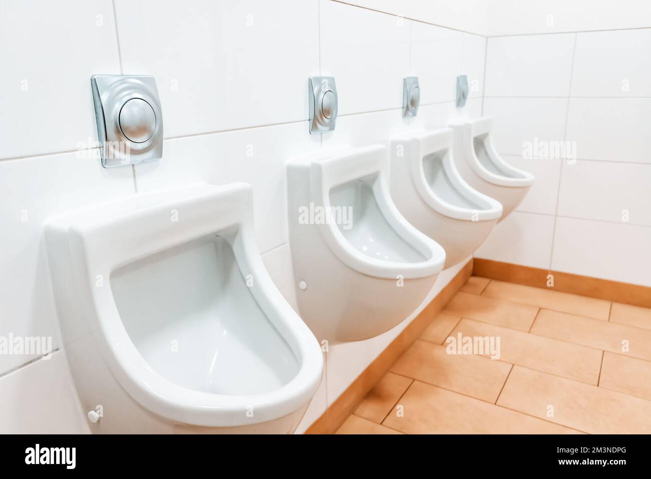 Urinals in a public men's toilet. The concept of sanitary cleaning and ...
