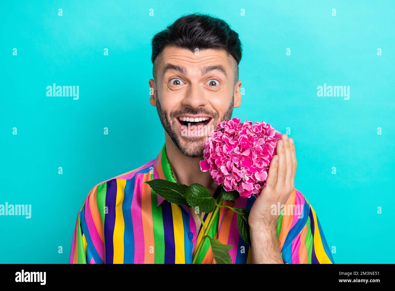 Portrait of impressed crazy person toothy smile hand hold touch flower ...