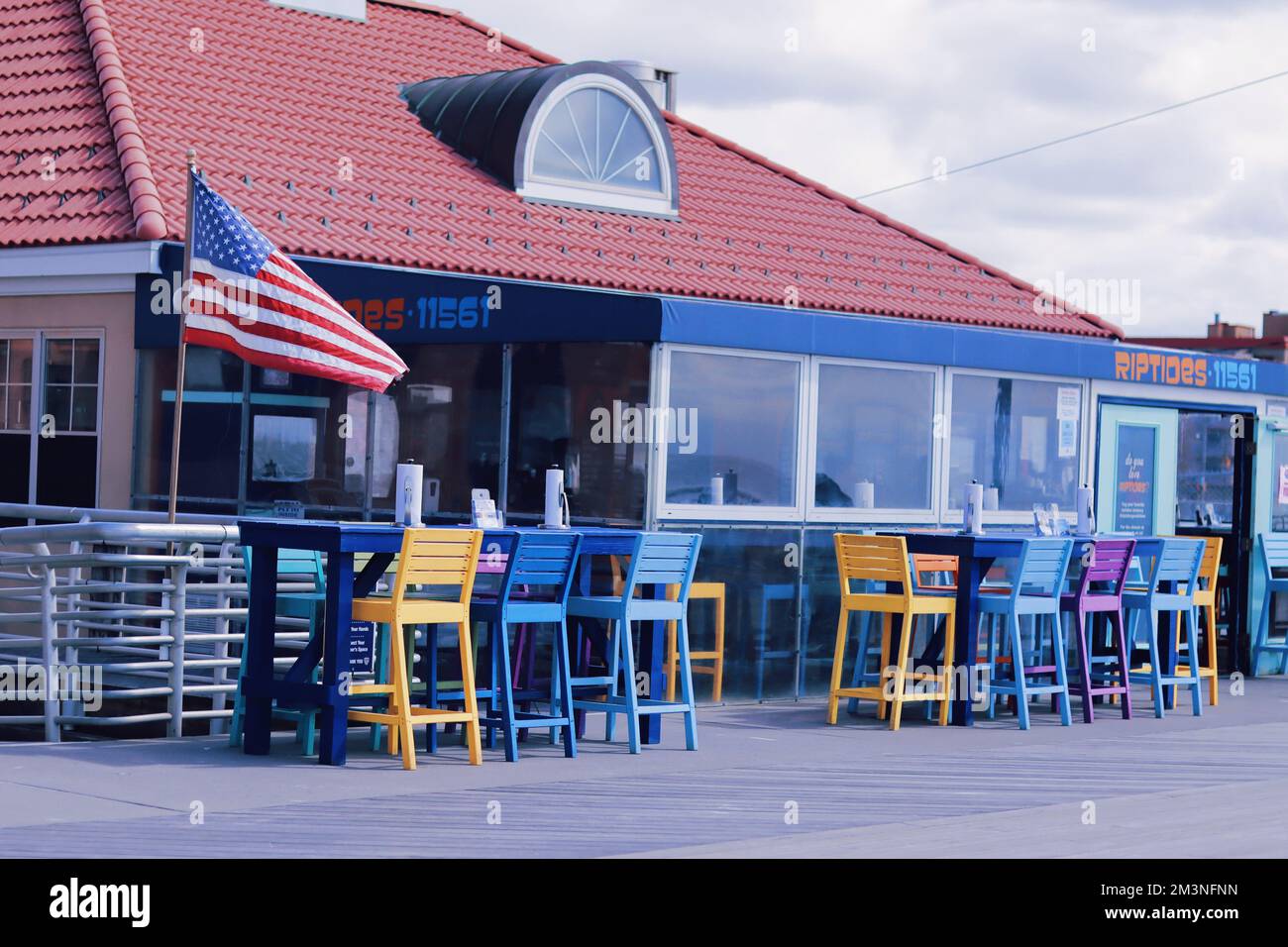 The colourful chairs outside a restaurant, with an American flag Stock ...