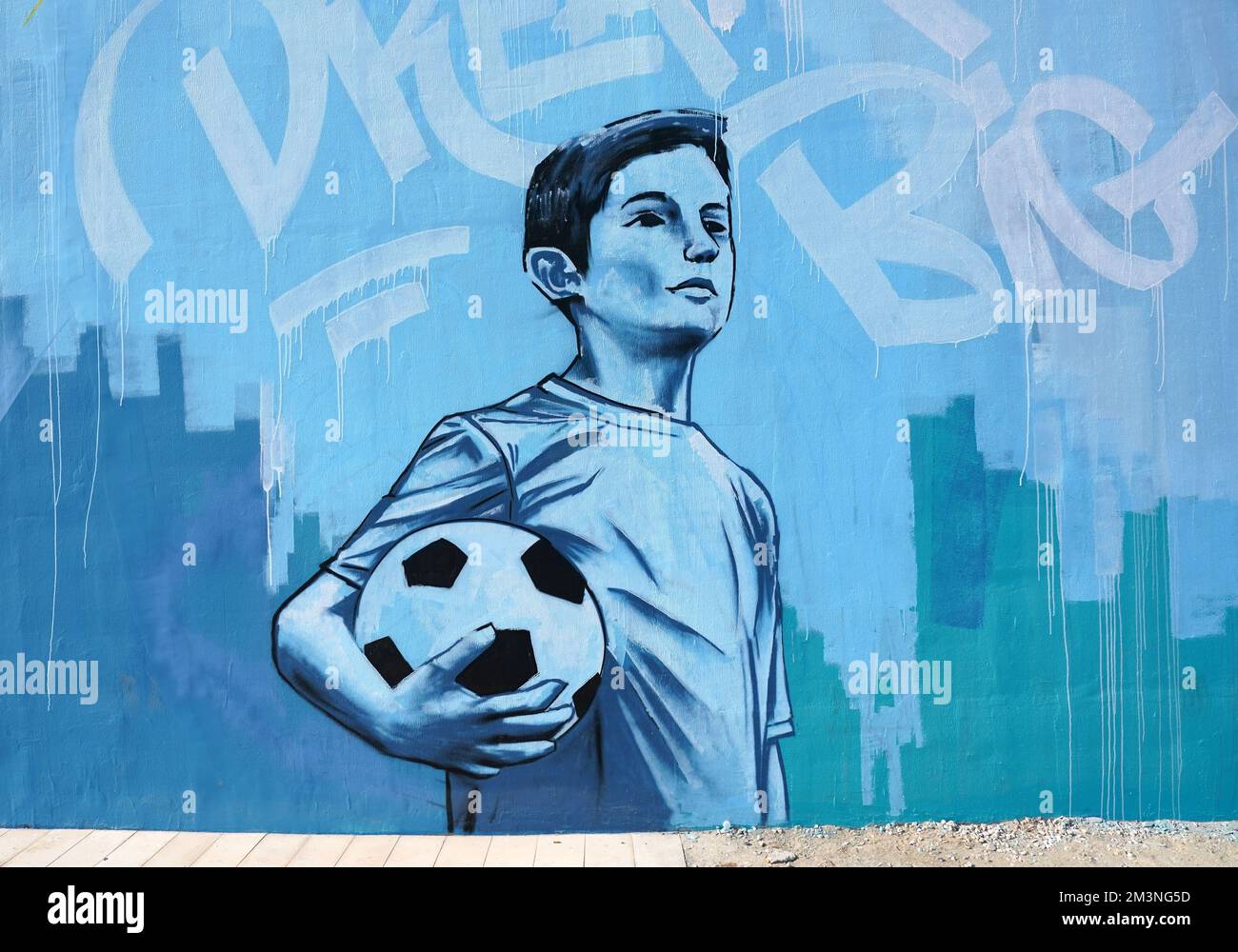 A mural of a young footballer near the Khalifa International Stadium ...