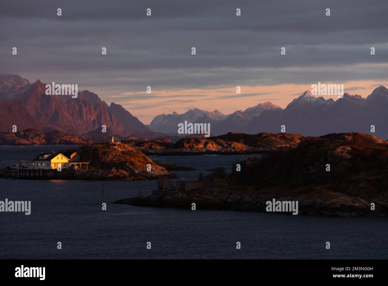 A beautiful sunset over the mountains and islands of Lofoten, Norway ...