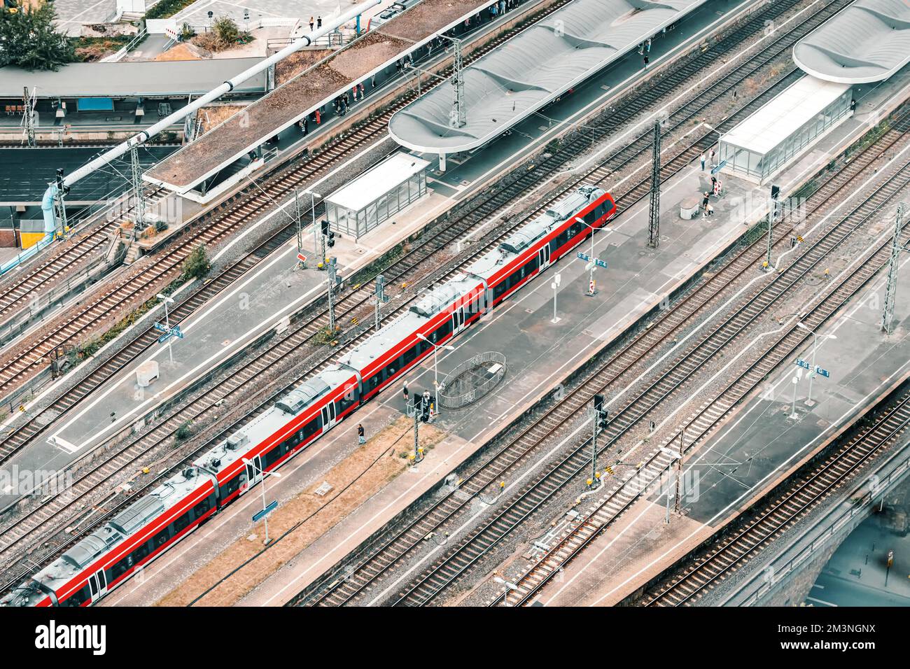 railway platform with passengers and a modern high-speed train ...