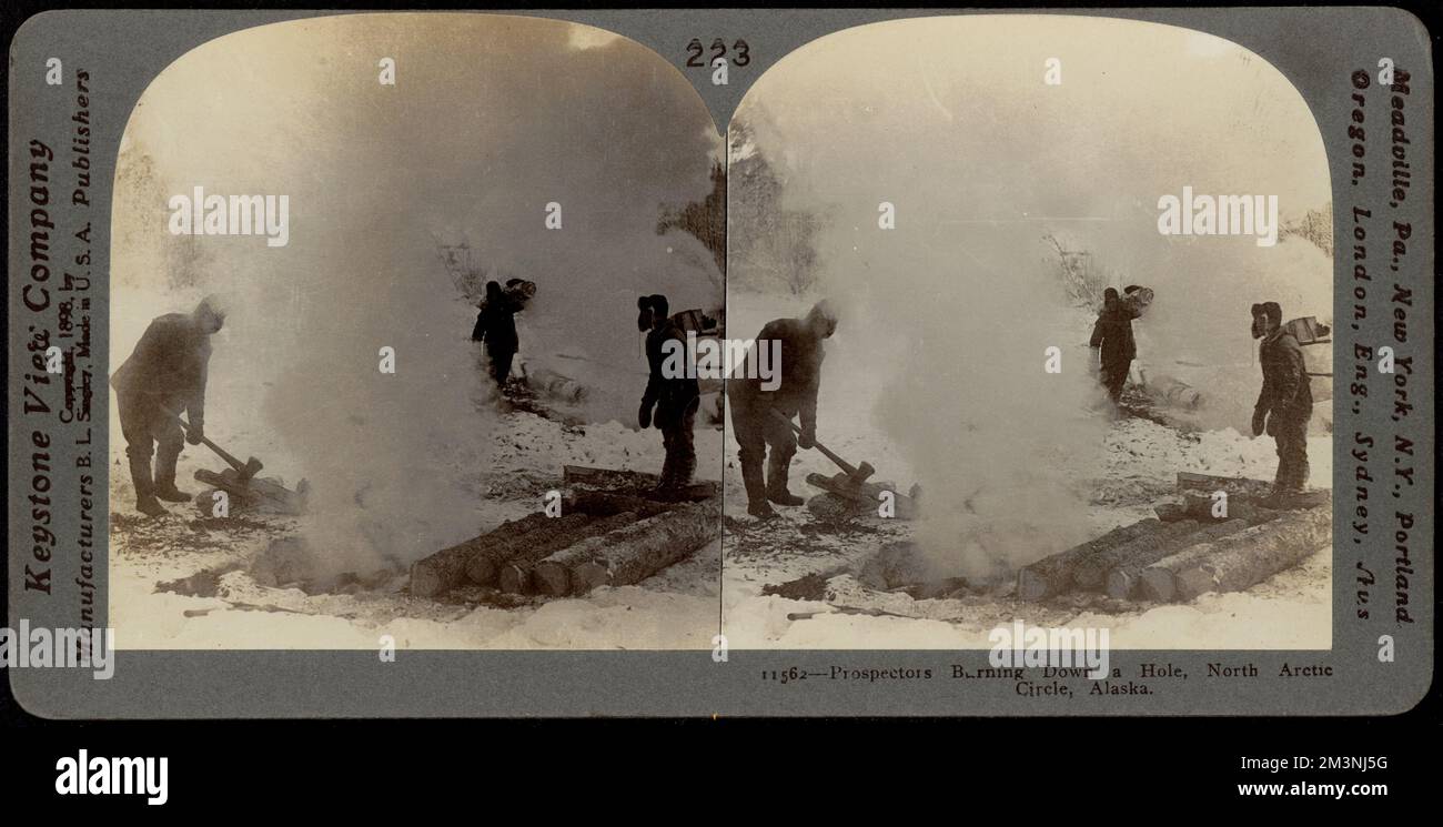 Prospectors burning down a hole, north of the Arctic Circle, Alaska ...