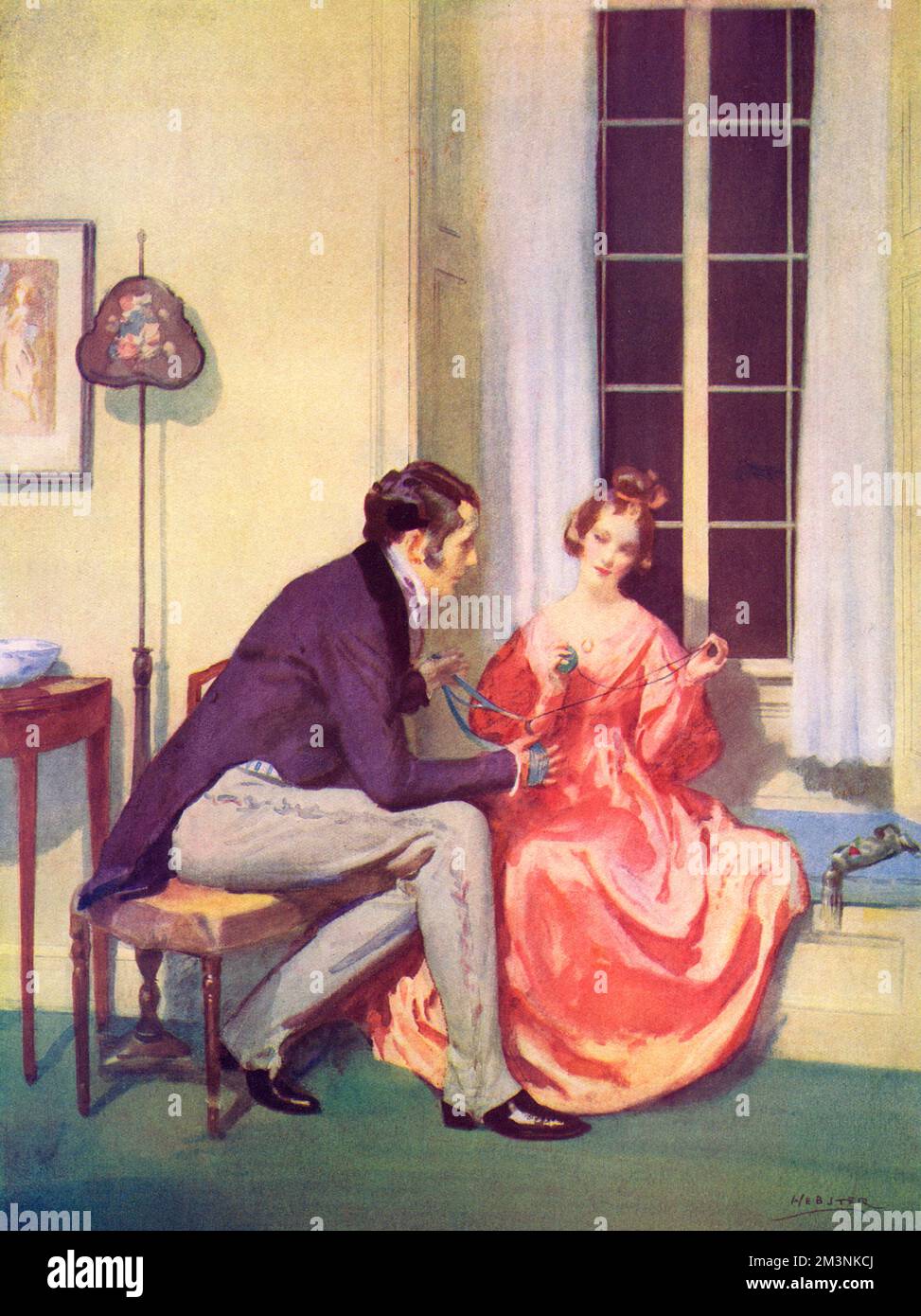 Entangled - two lovers play with wool Stock Photo - Alamy