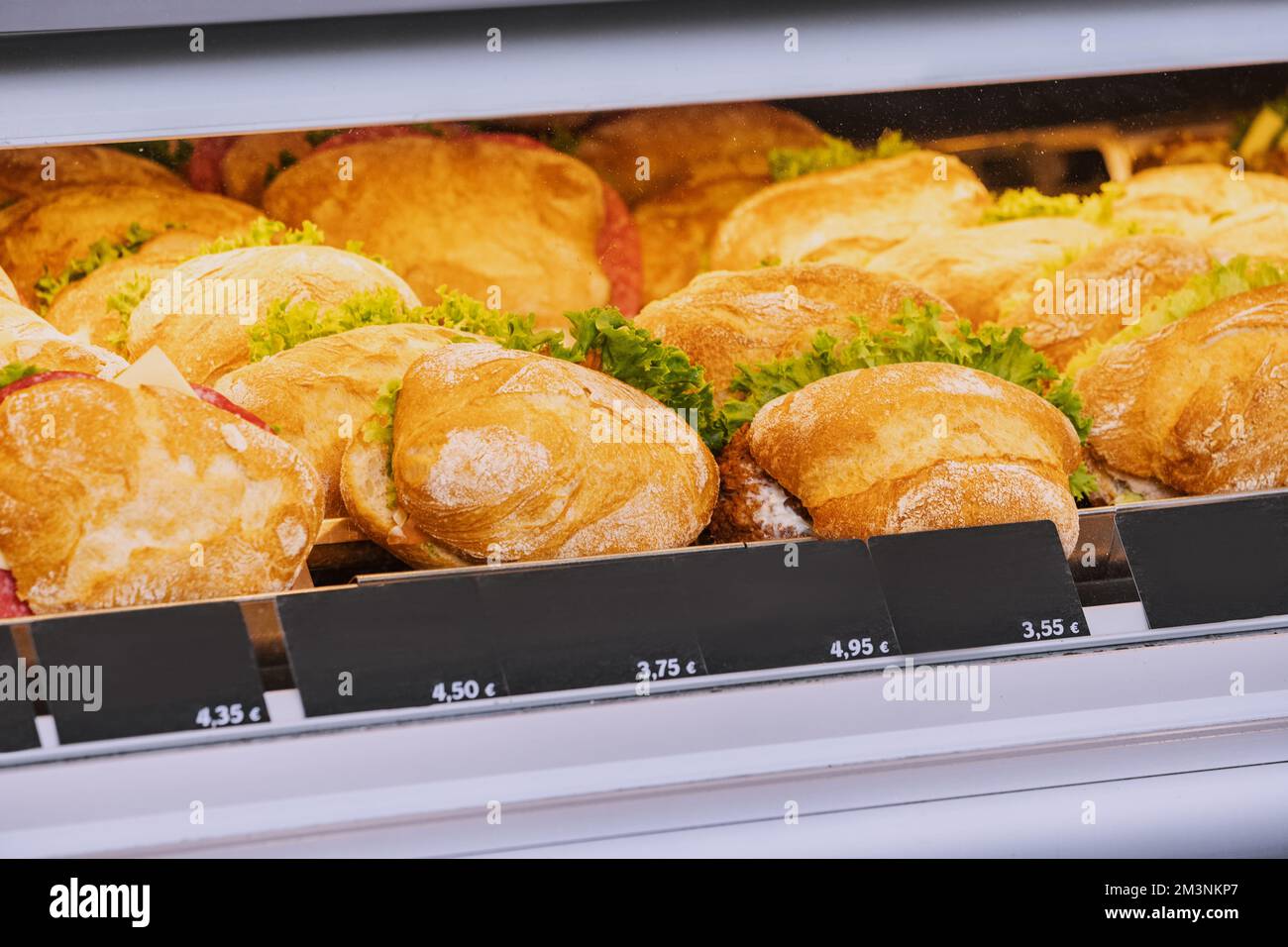 Variety of tasty sandwiches with various fillings in the window of a ...