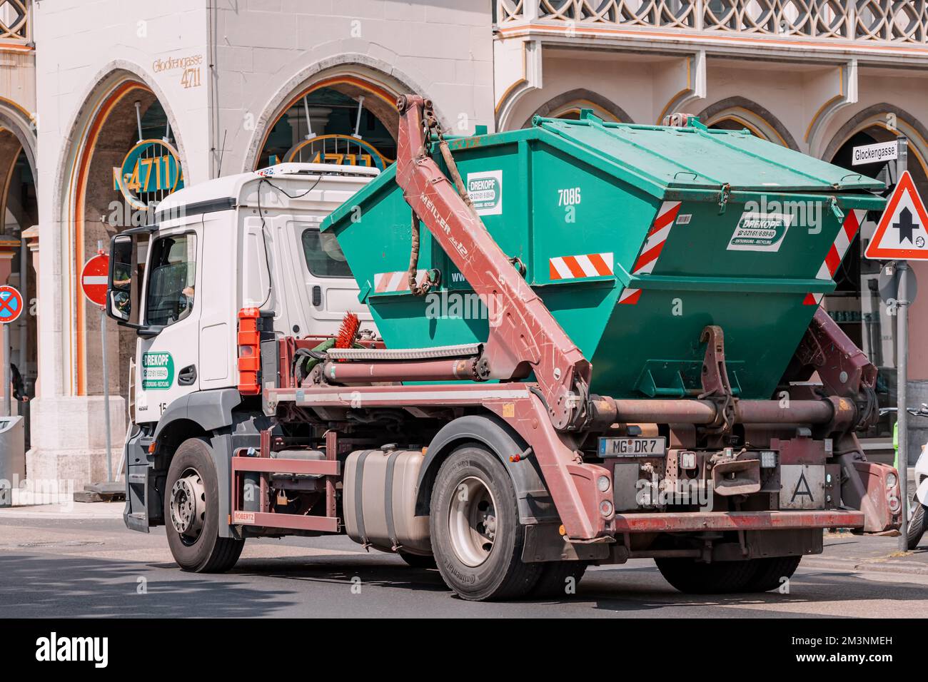 29 July 2022, Cologne, Germany: Truck with waste and rubbish container ...