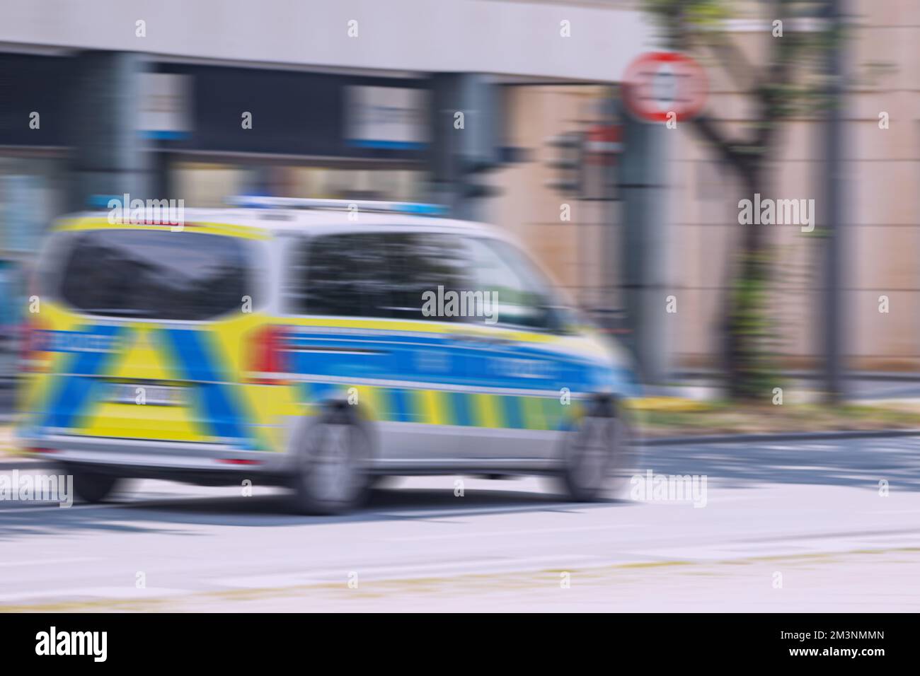 Motion Blur of a German polizei or police car van is rushing on city ...