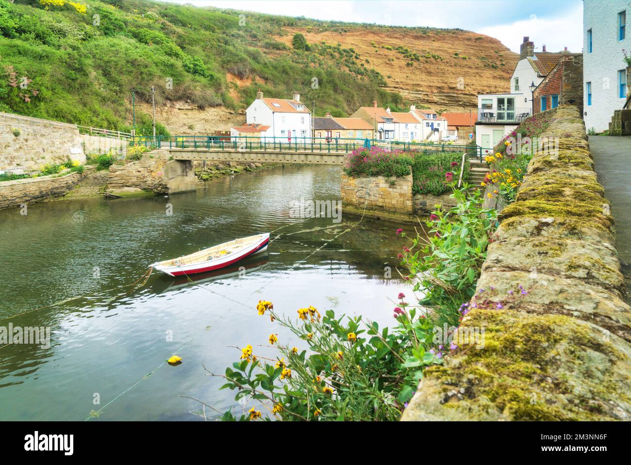 Looking east down Staithes Beck (river) towards sea and harbour, at the ...