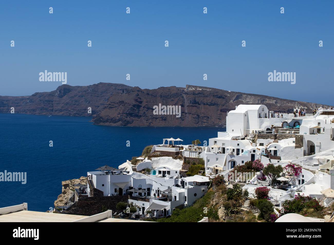 An aerial view of Oia village marble buildings before the sea on a ...