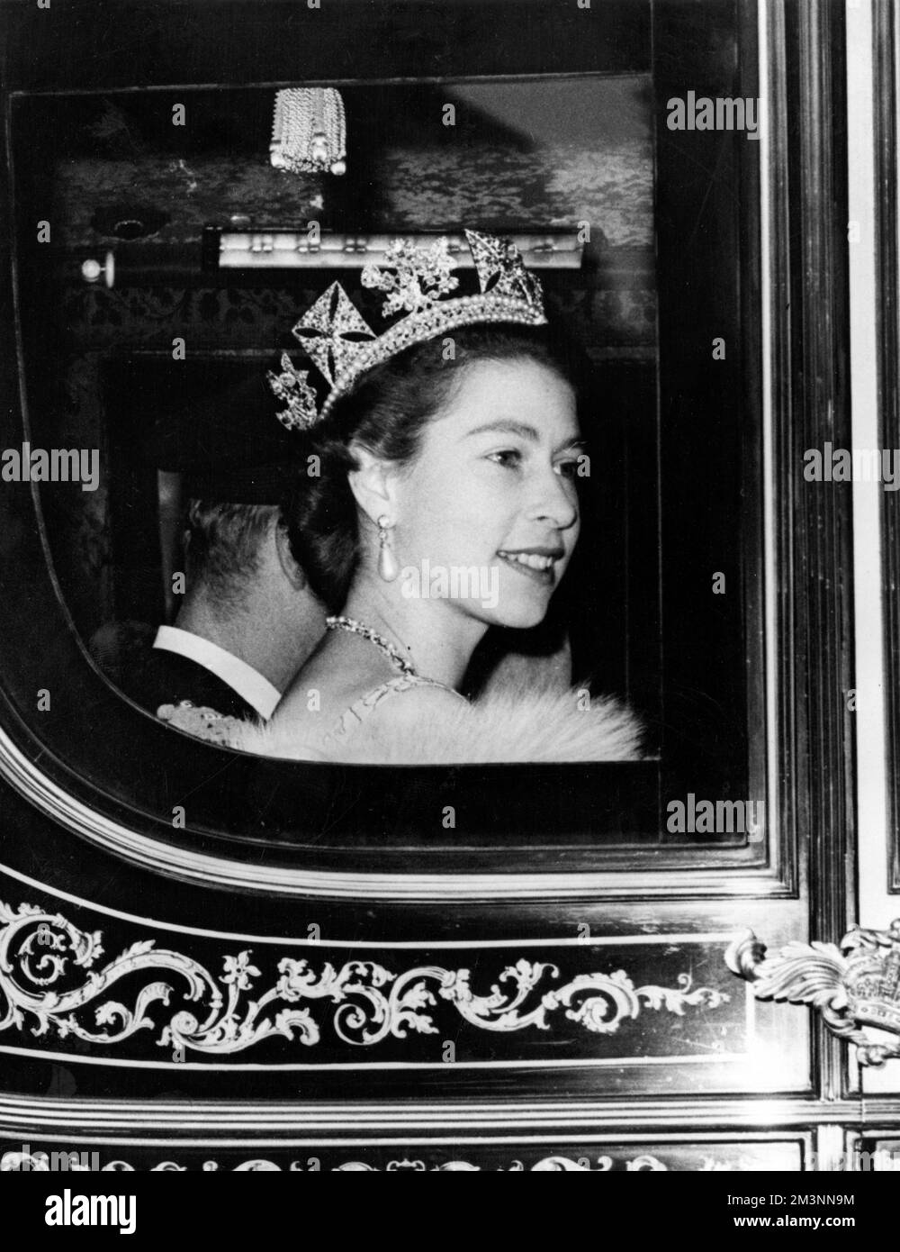 Queen Elizabeth II smiles regally as she travels to Westminster to open ...