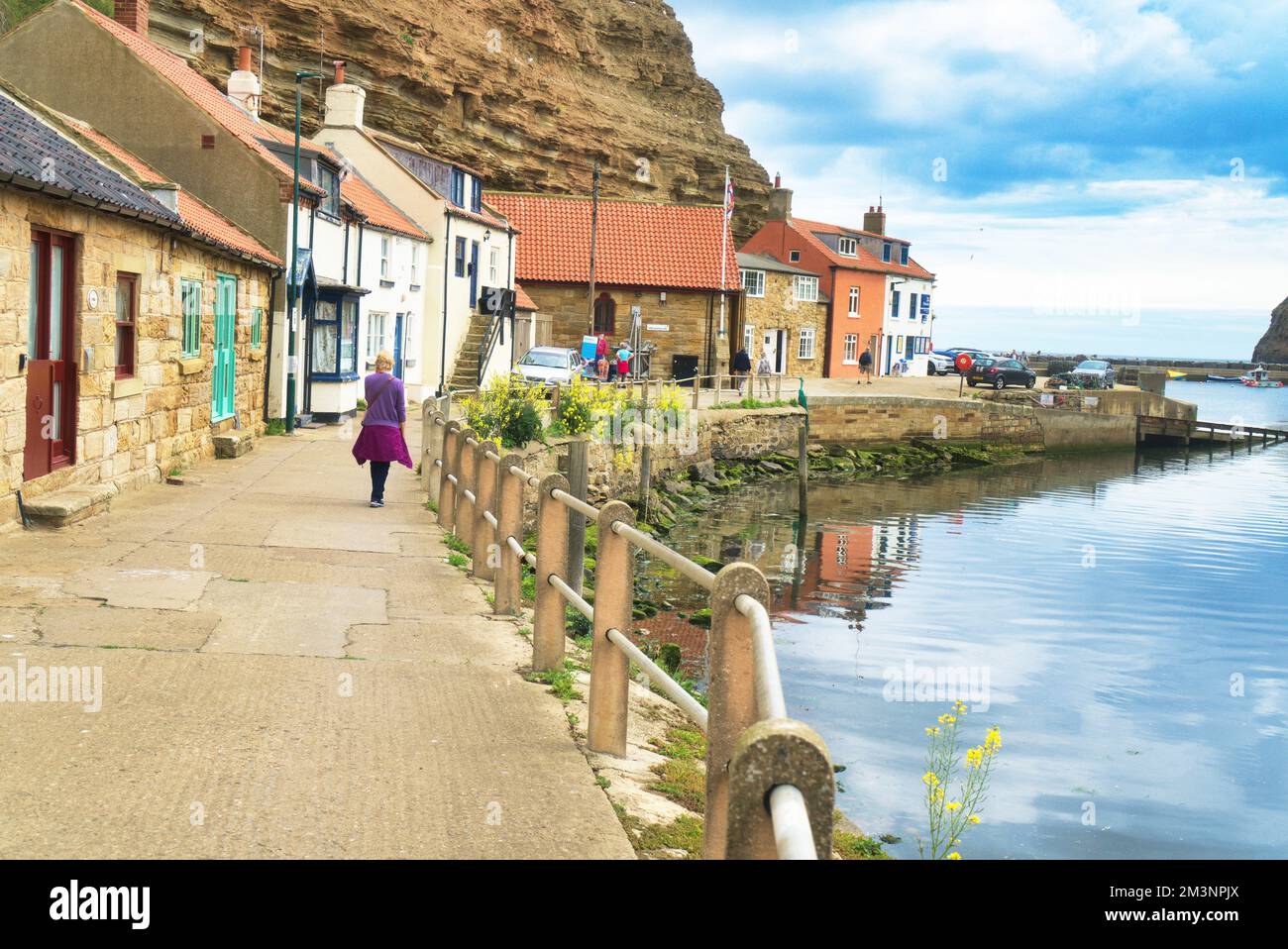 Looking east down Staithes Beck (river) towards harbour and sea at the ...