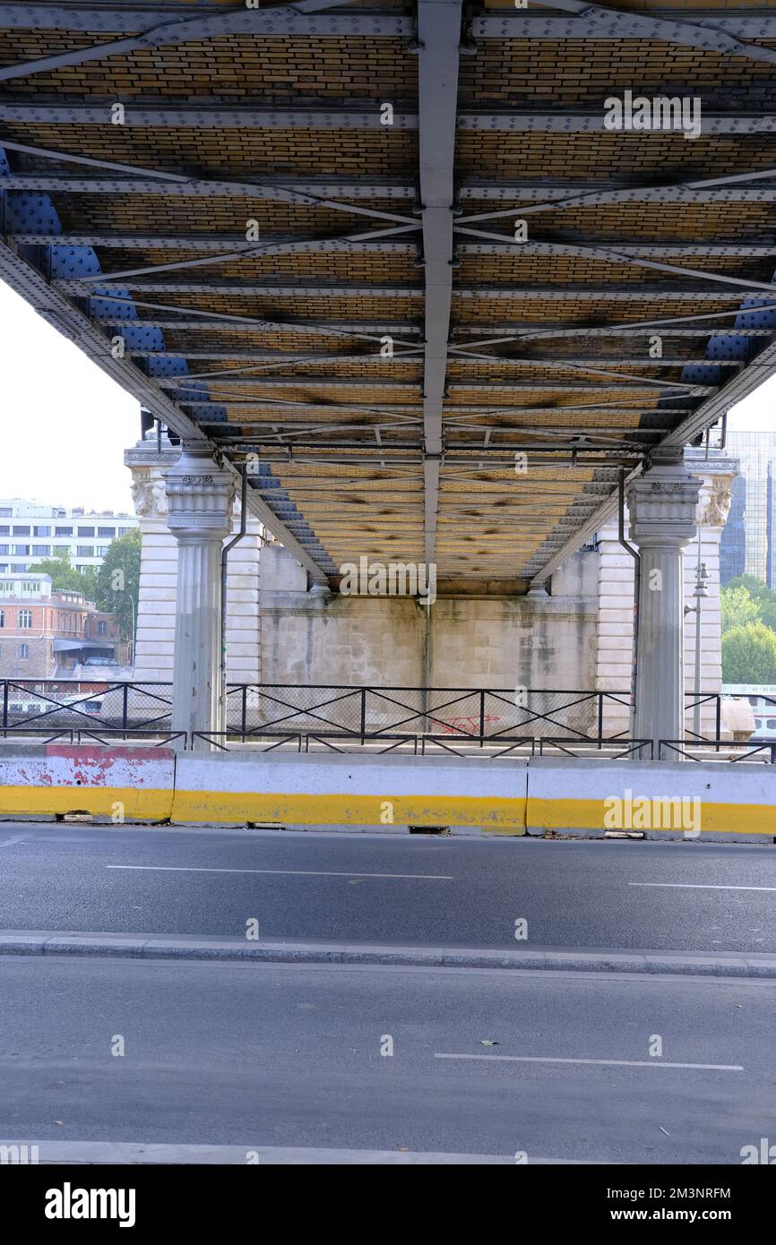 A vertical shot of a road under a steel bridge in Paris, France Stock ...