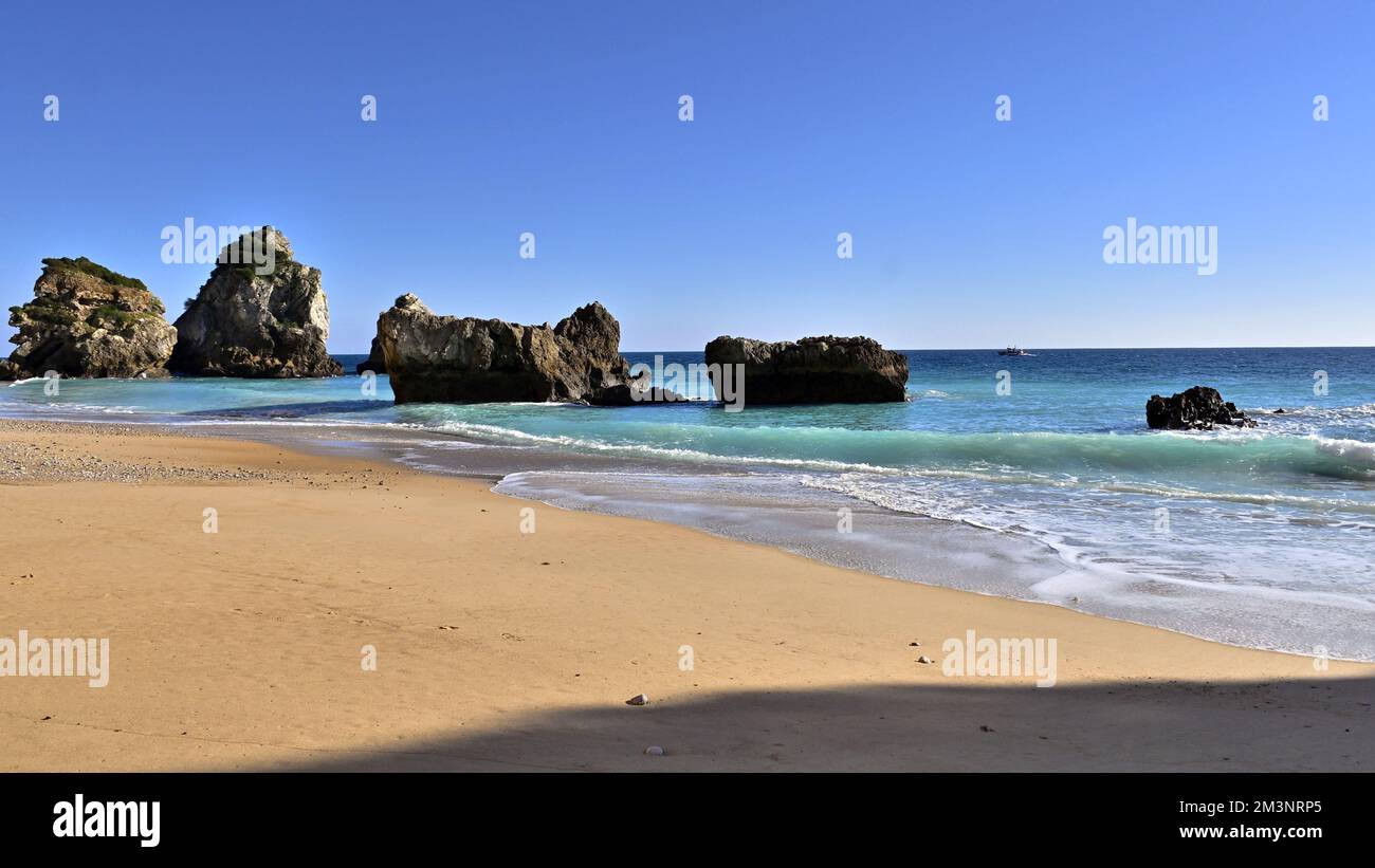 A beautiful view of Ribeiro do Cavalo Beach with rock formations in the ...
