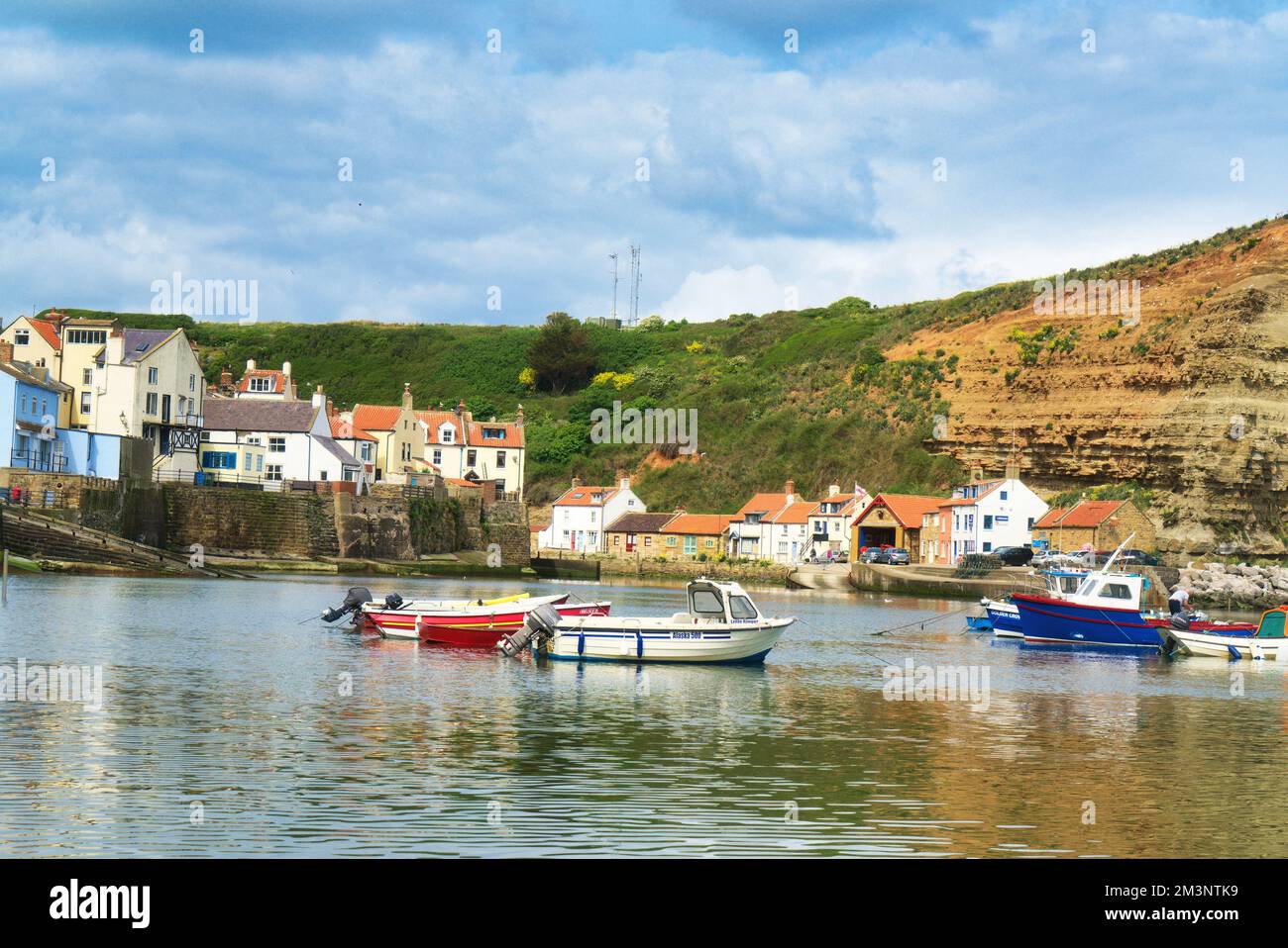 Staithes harbour, beach and cliffs from beach at high tide. North ...