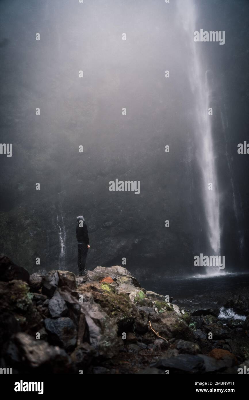 Person standing waterfall hi-res stock photography and images - Alamy
