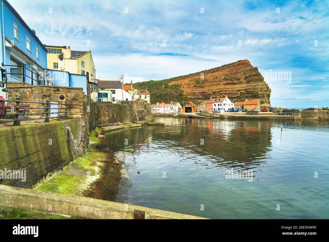 Staithes harbour, beach and cliffs from beach at high tide. North ...