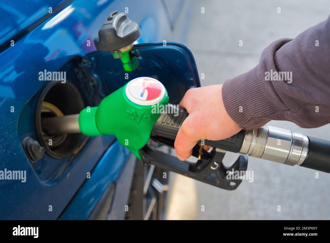 Pumping gasoline fuel in car at a gas station. To fill car with fuel in ...