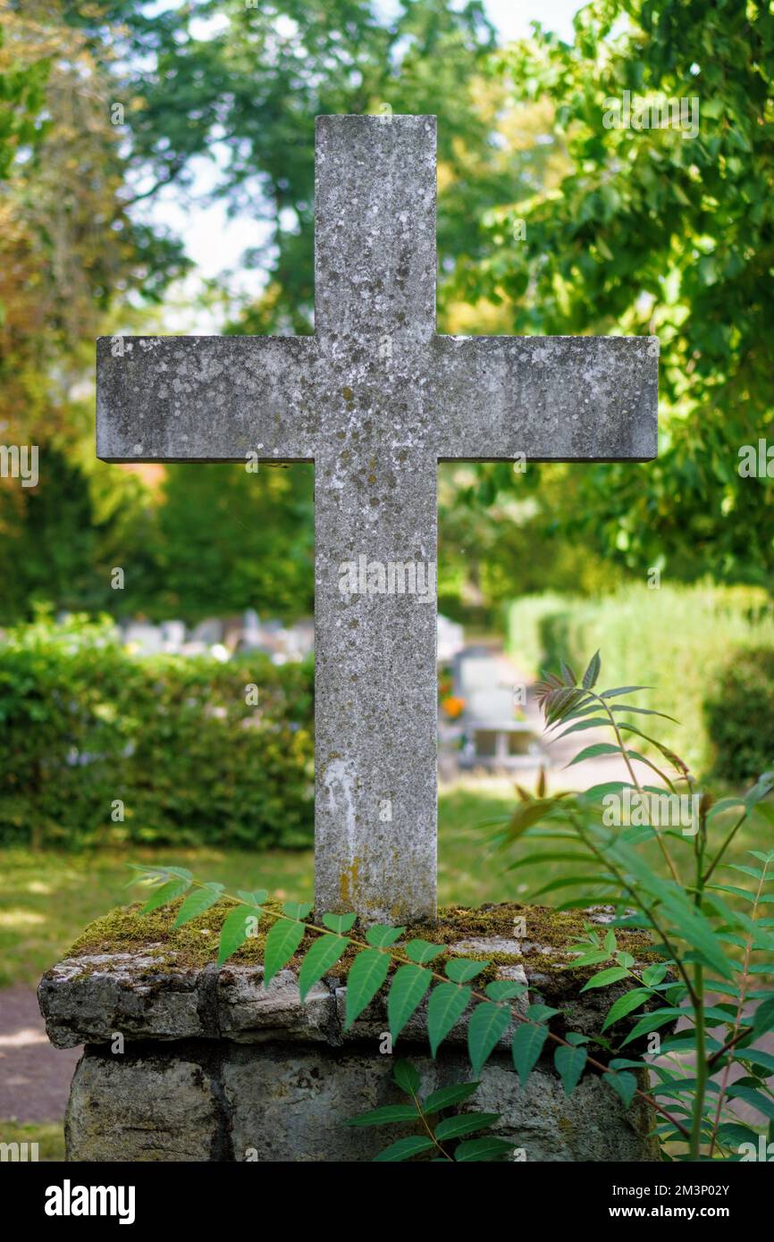 A vertical shot of a granite stone cross in a park Stock Photo - Alamy