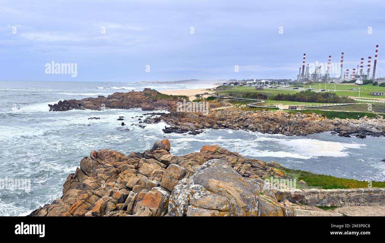 A scenic sandy seascape with the power station n the background on a ...