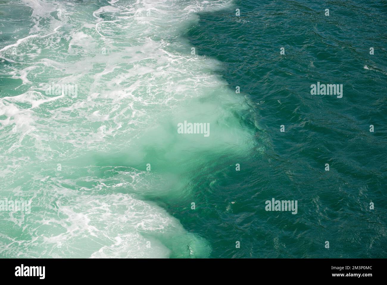 The sea water texture with foam from the thrust of a large propeller ...