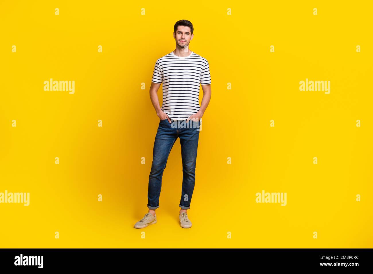 Full length photo of pretty cheerful guy dressed striped t-shirt hands ...
