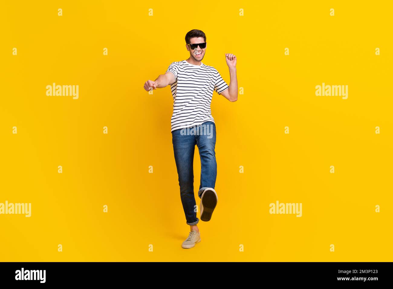 Full length photo of positive cool guy dressed striped t-shirt dark ...