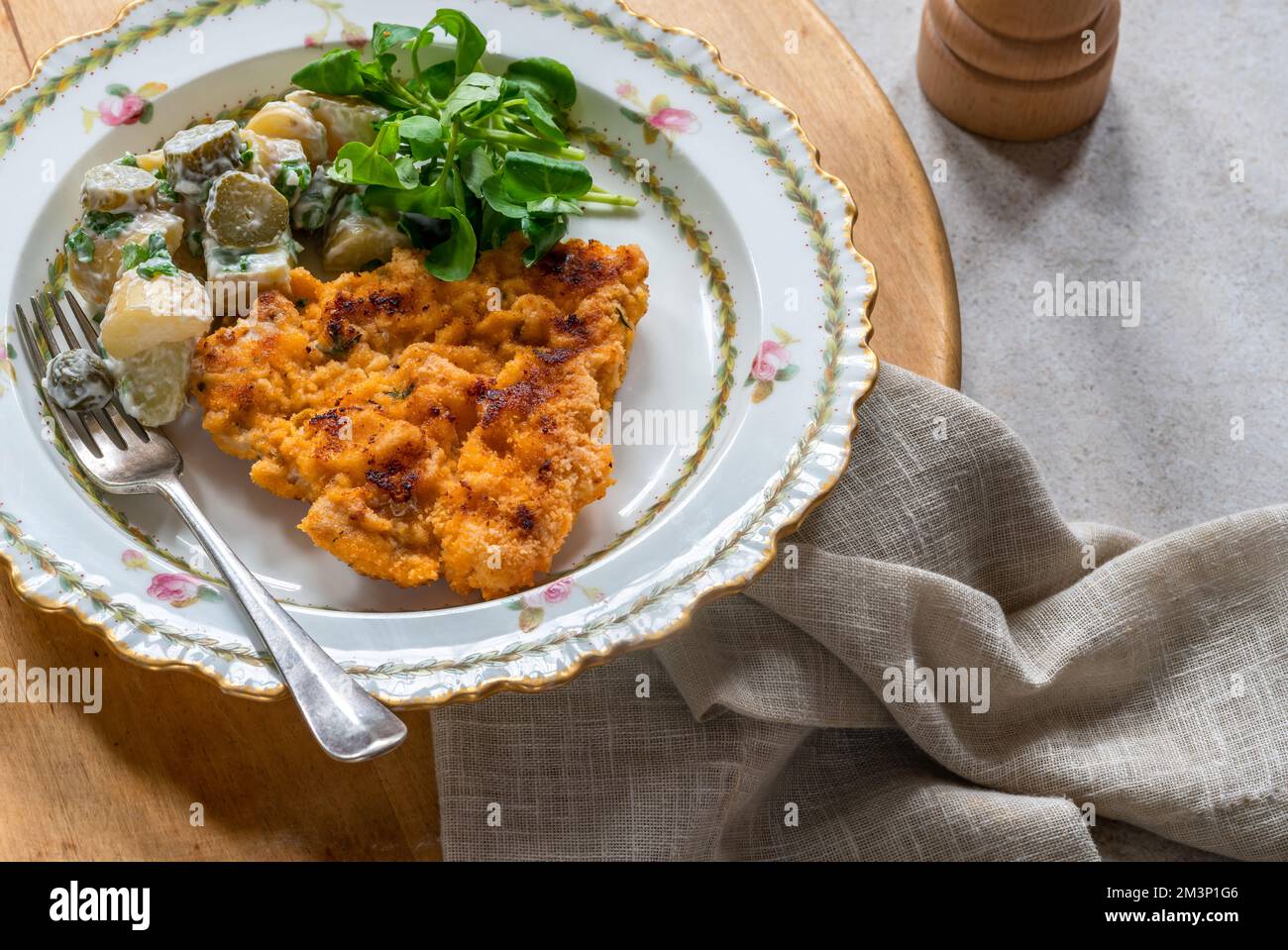 Lemon and thyme pork schnitzel with potato salad Stock Photo - Alamy