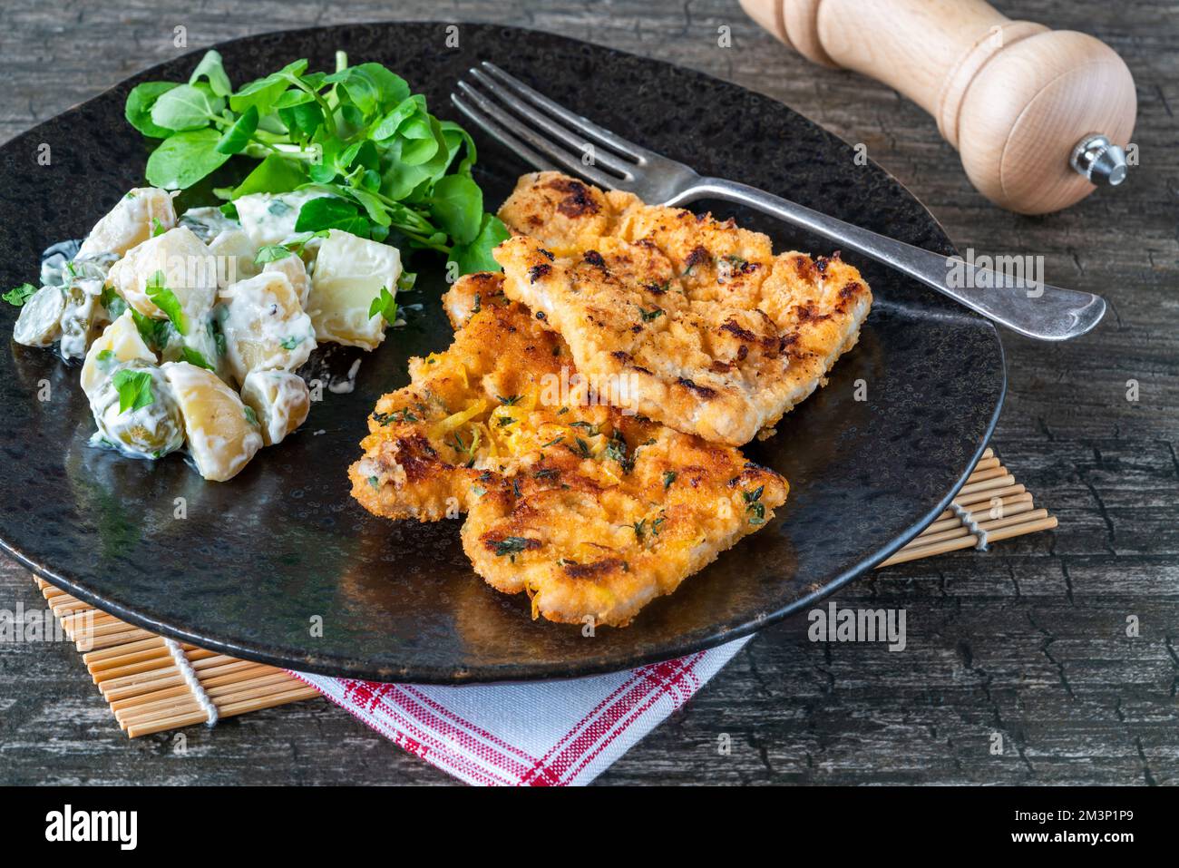 Lemon and thyme pork schnitzel with potato salad Stock Photo - Alamy