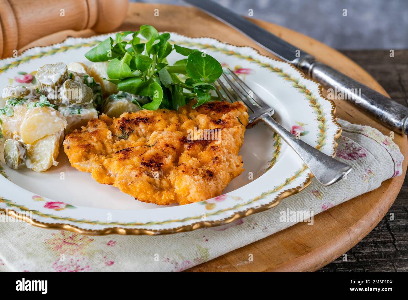 Lemon and thyme pork schnitzel with potato salad Stock Photo - Alamy