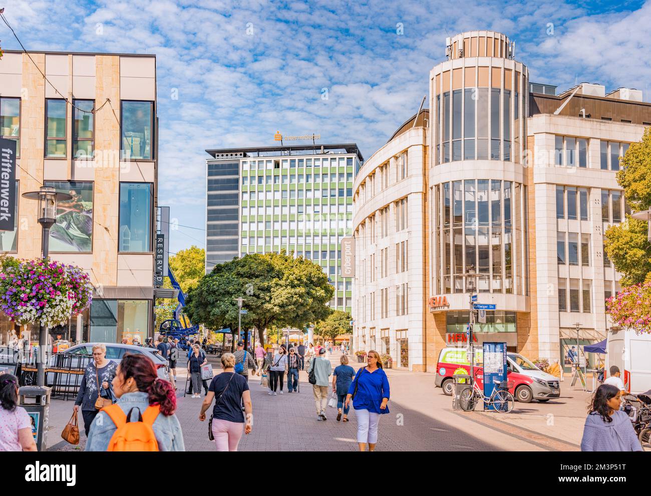 28 July 2022, Essen, Germany: Panoramic view of city life. People and ...