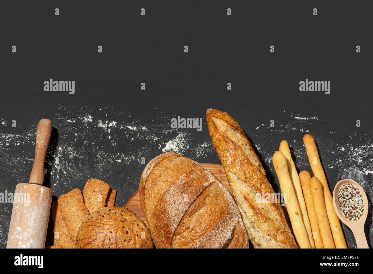 Freshly baked bread on a gray dark background. Background with buns and ...