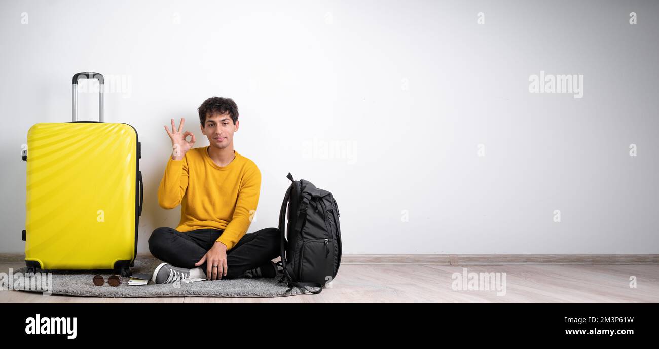 Arabic man traveler with suitcase looking happy and showing sign ok and ...