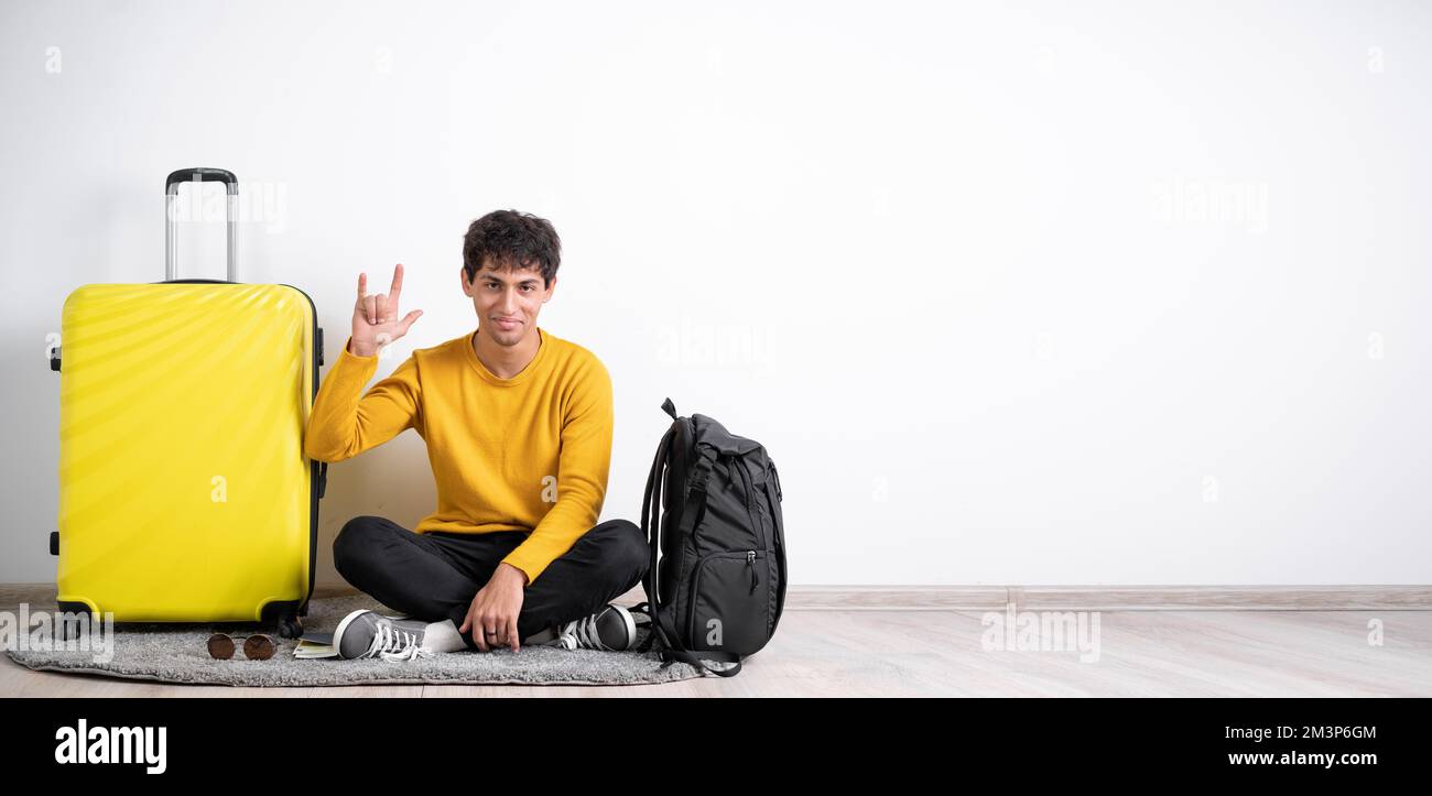 Traveler hand showing rock n roll sign or giving the devil horns ...