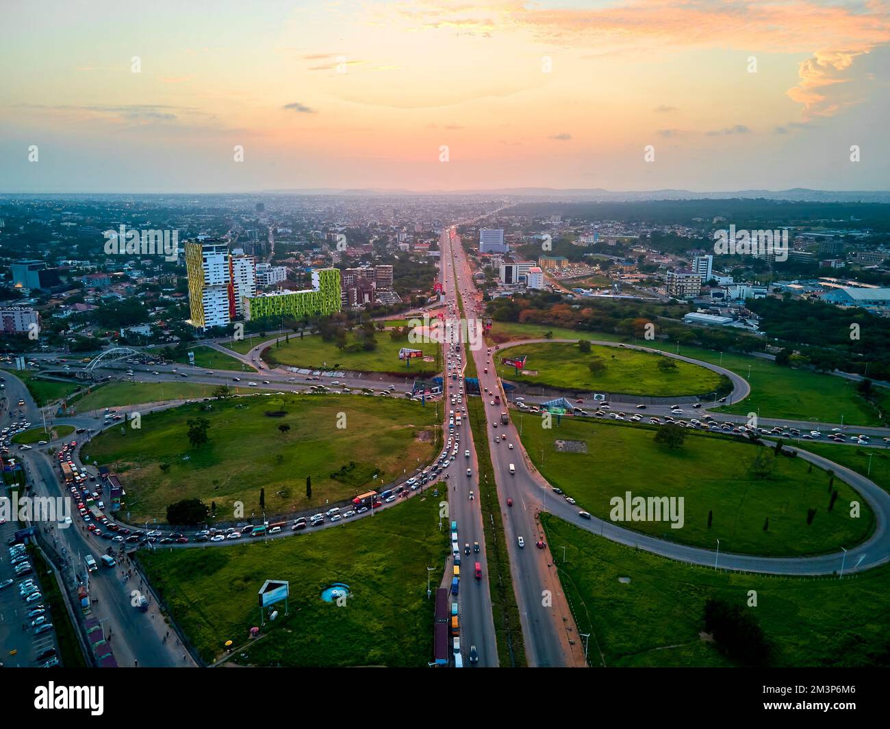 An aerial view of a multiple lane highway road with traffic at sunset ...