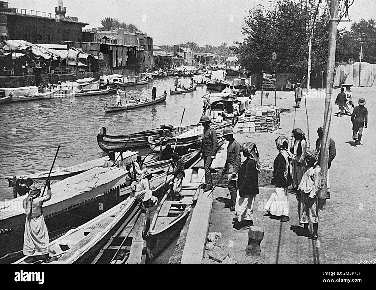 A view of the creek at Basra, showing British soldiers hiring a ballam ...