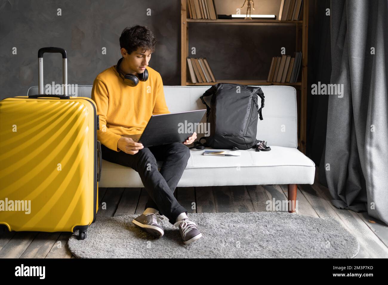 Young man traveler planning vacation trip and using computer to book ...