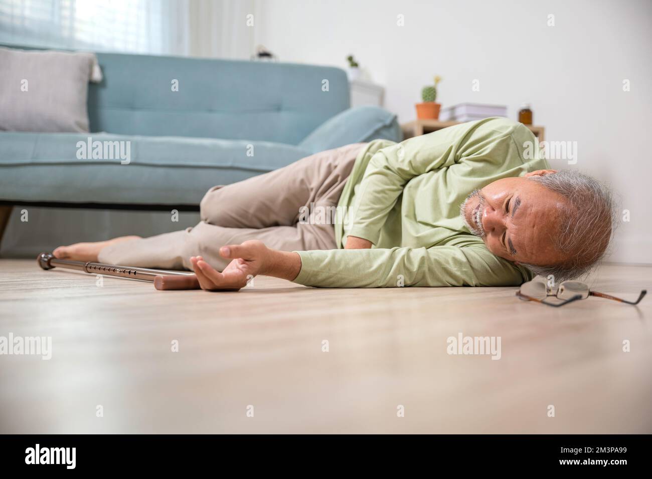 Sick senior old man falling down lying on floor because stumbled at ...
