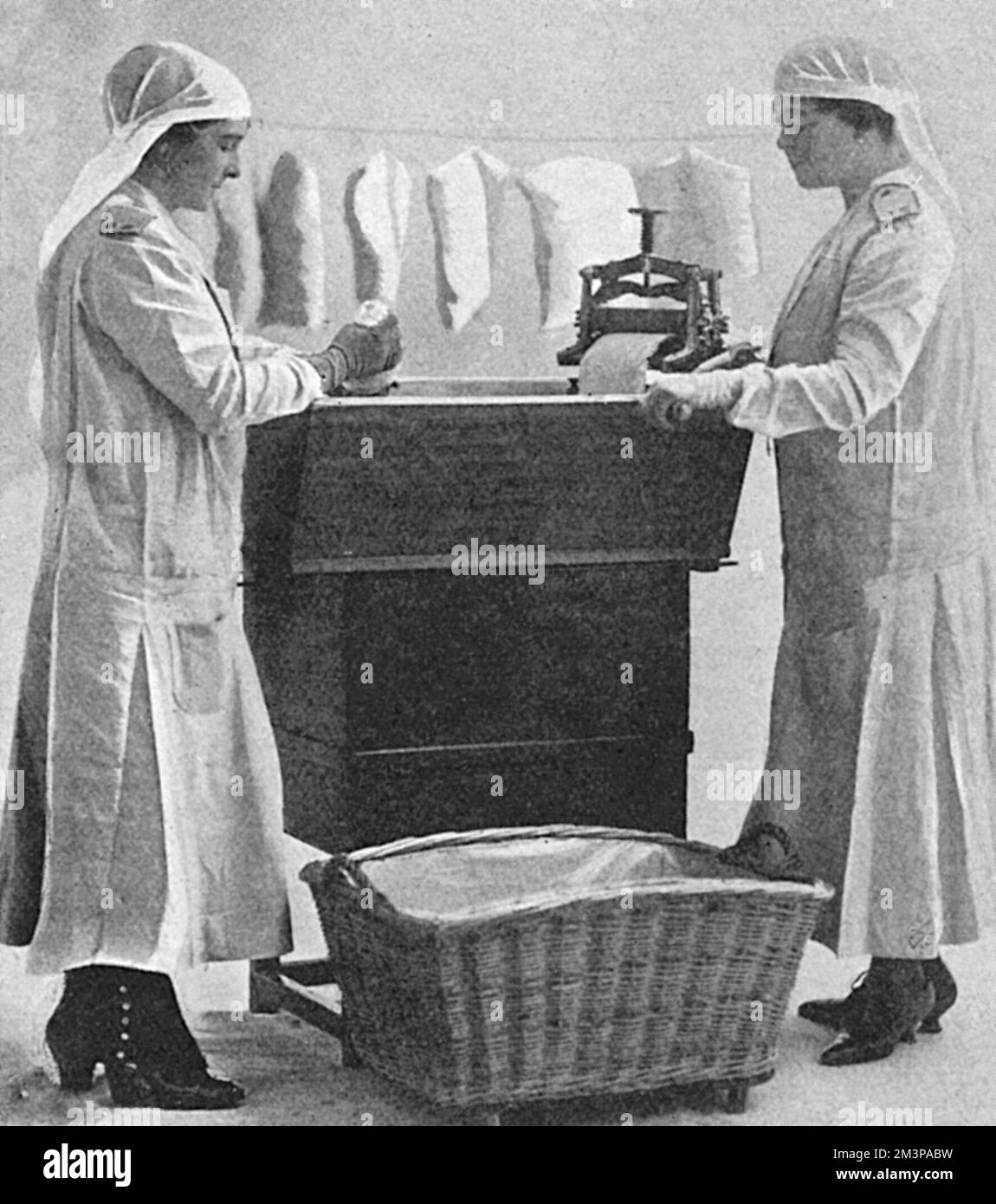 Mrs Lawrence & Mrs Mason carbonising garments for troops,WW1 Stock ...