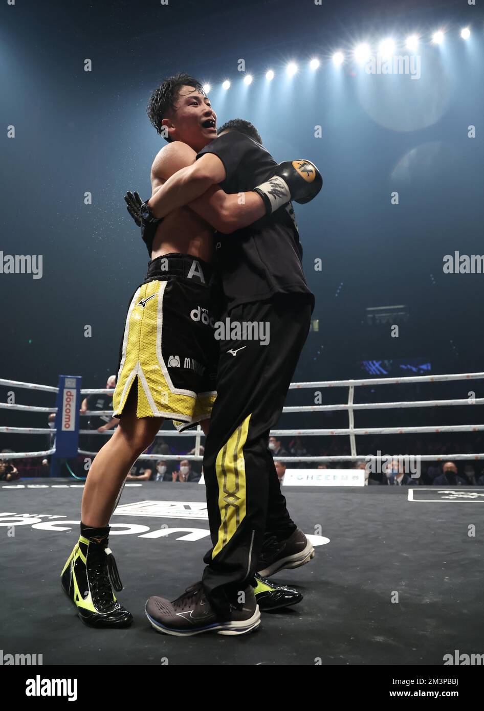 Japan's Naoya Inoue (L) hugs his father and trainer Shingo Inoue after ...