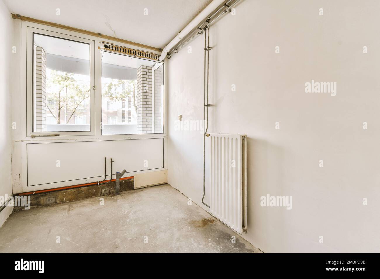 an empty room with white walls and no one person in the room looking ...