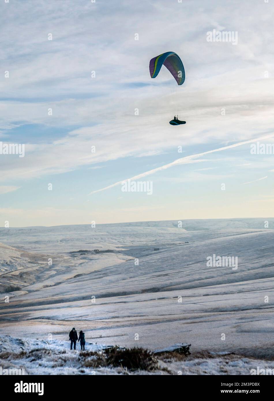 A paraglider over Marsden Moor in the South Pennines. Snow and ice have ...