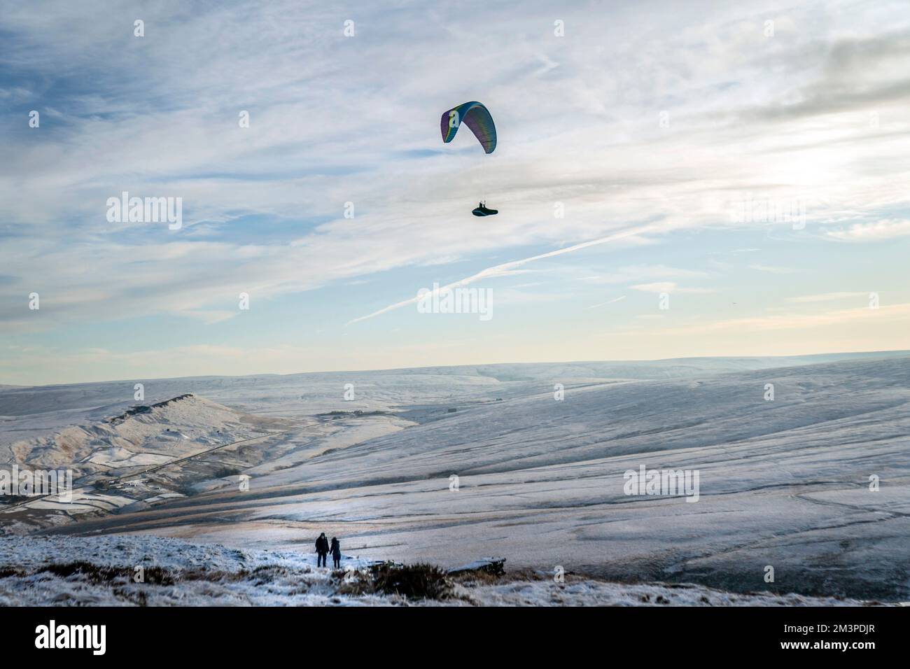 A paraglider over Marsden Moor in the South Pennines. Snow and ice have ...
