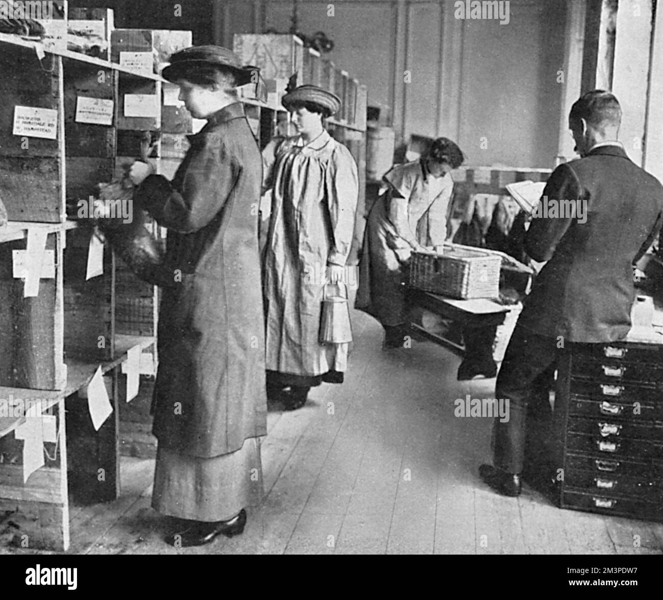 Pigeon holes being filled with provisions for Belgian refugees and ...